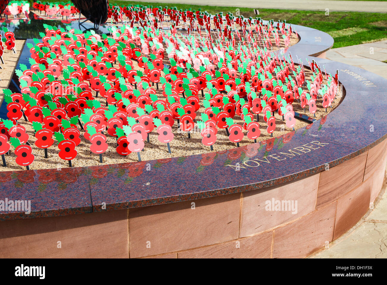 A poppy memorial built in the shape of a poppy with red poppies on it ...