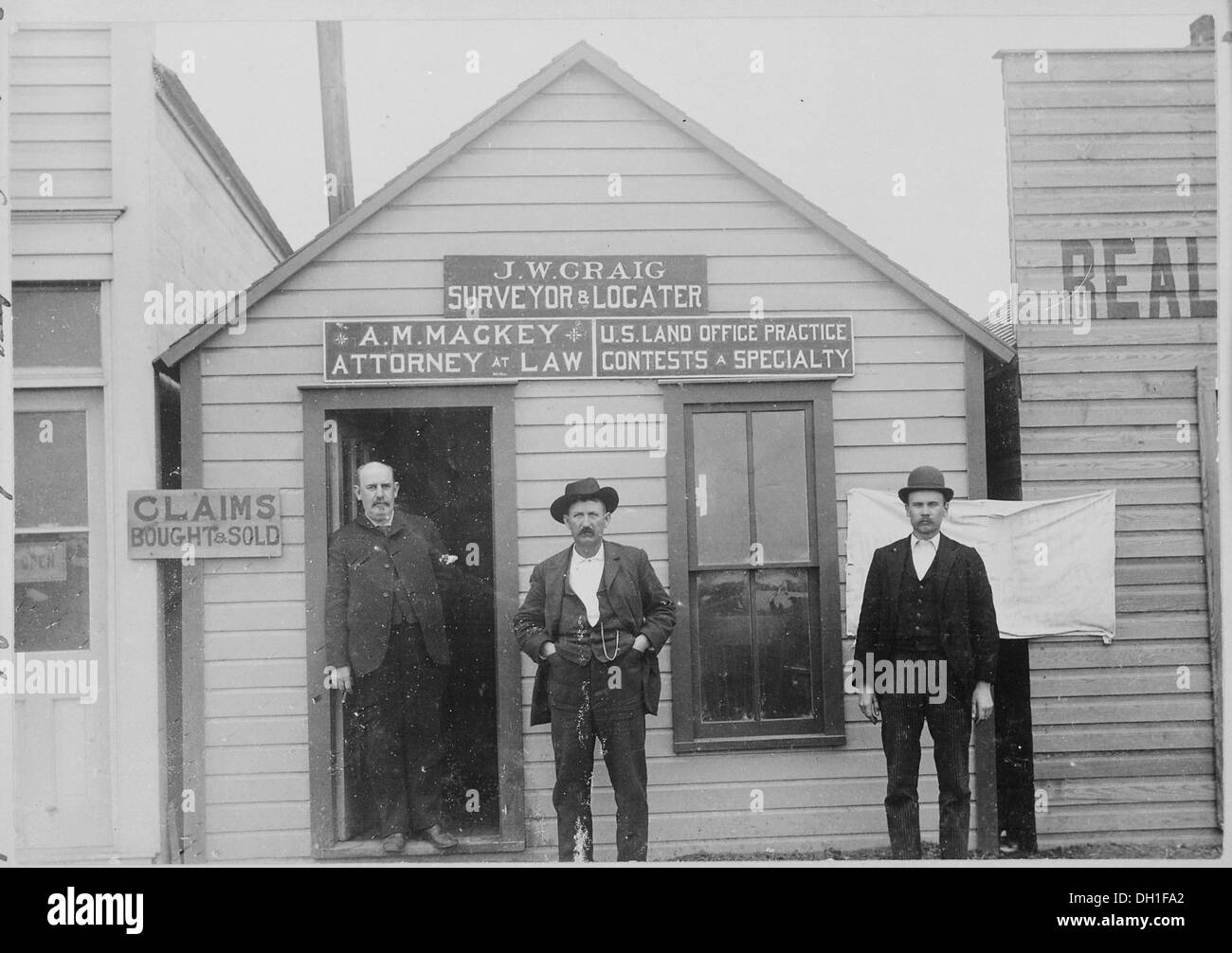Attorneys and surveyors are pictured in front of the U.S. Land Office ...