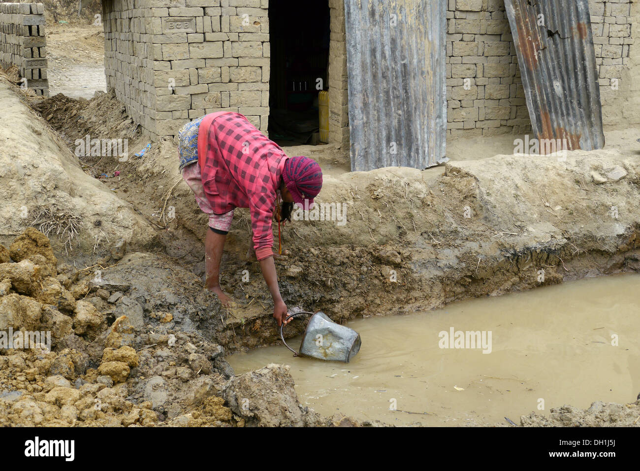 Brickmaker family washing pots in dirty water, Nepal, Godavari Stock ...