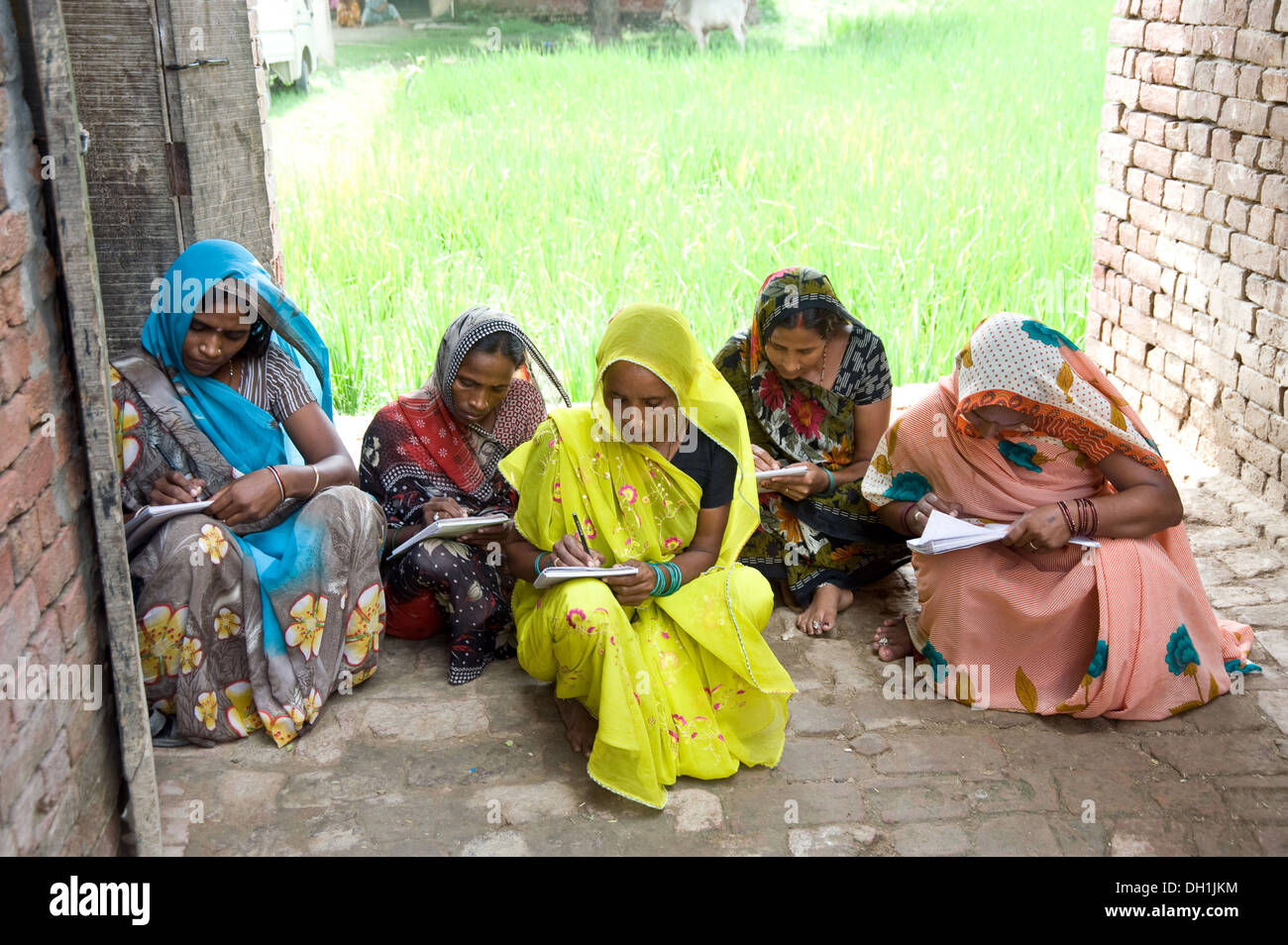 five rural indian women writing studying adult education uttar pradesh ...