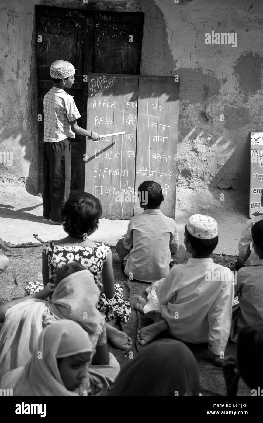 Muslim boy teaching English blackboard Islamic school of children Uttar ...