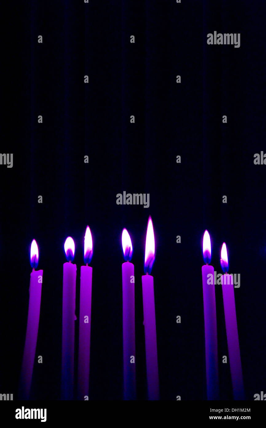 seven violet purple burning candles flame black background Stock Photo ...