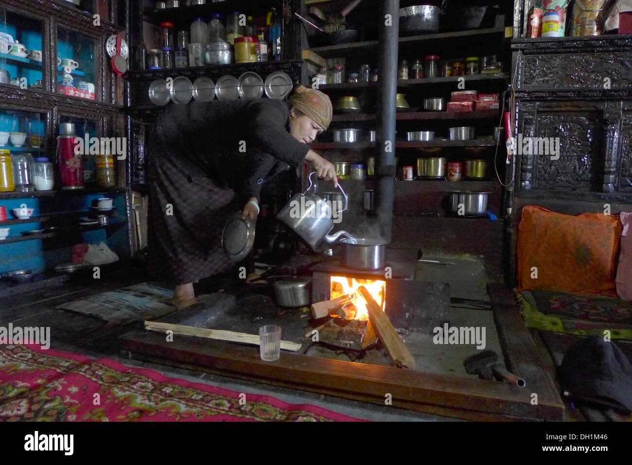 Nepal Malemchigaun Sherpa village, Langtang. Kingomu Sherpa making tea ...