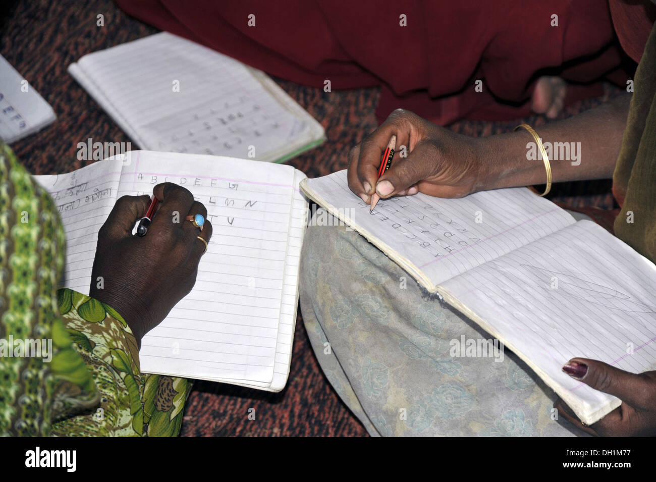 adult education Indian women writing pencil ABCD note book India Stock ...