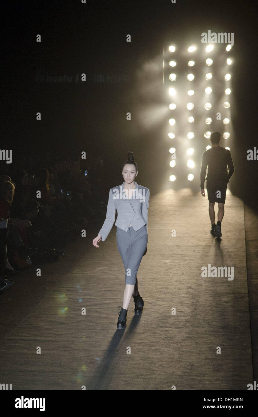 A model showcases clothes designs on the catwalk at the HUAFU Gioia Pan ...