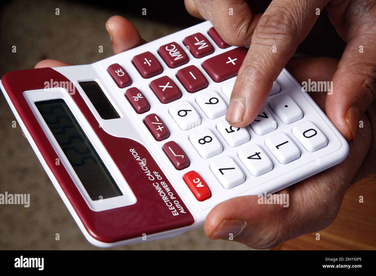 man working calculating on small table calculator , closeup of ...