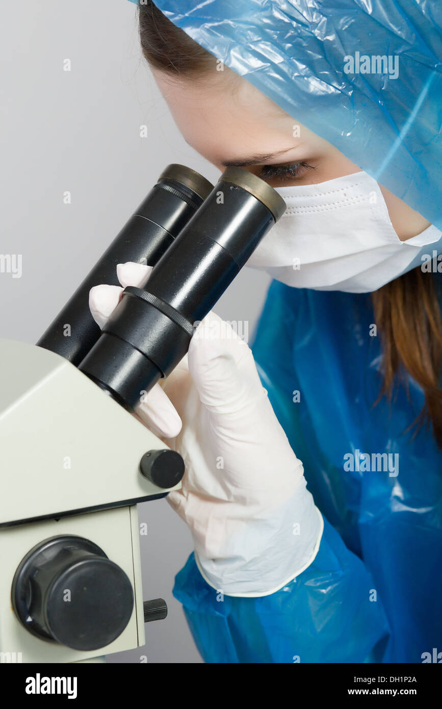 girl looking through a microscope Stock Photo - Alamy