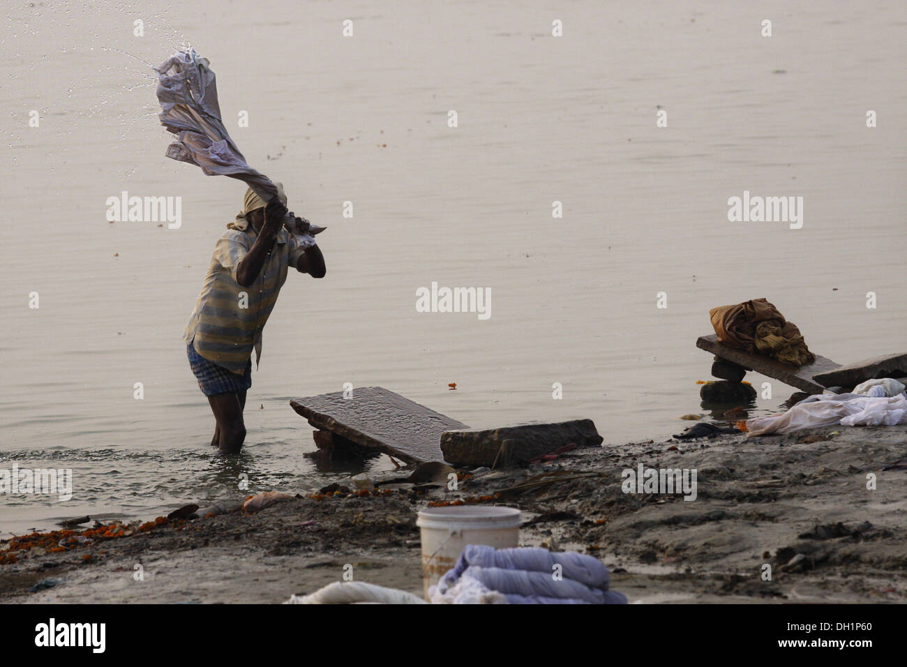 man washing clothes ganga river ganges varanasi uttar pradesh India ...