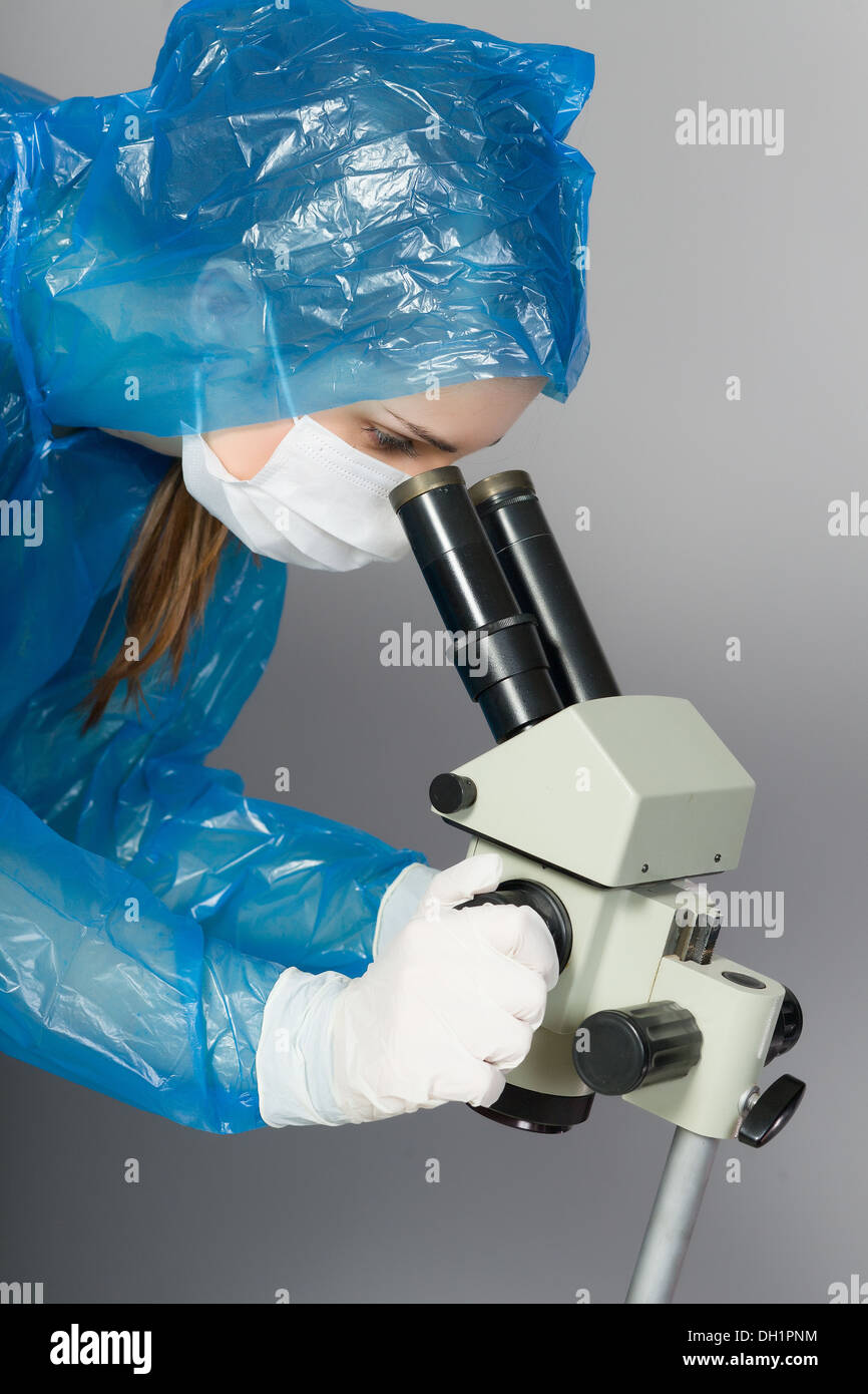 girl looking through a microscope Stock Photo - Alamy