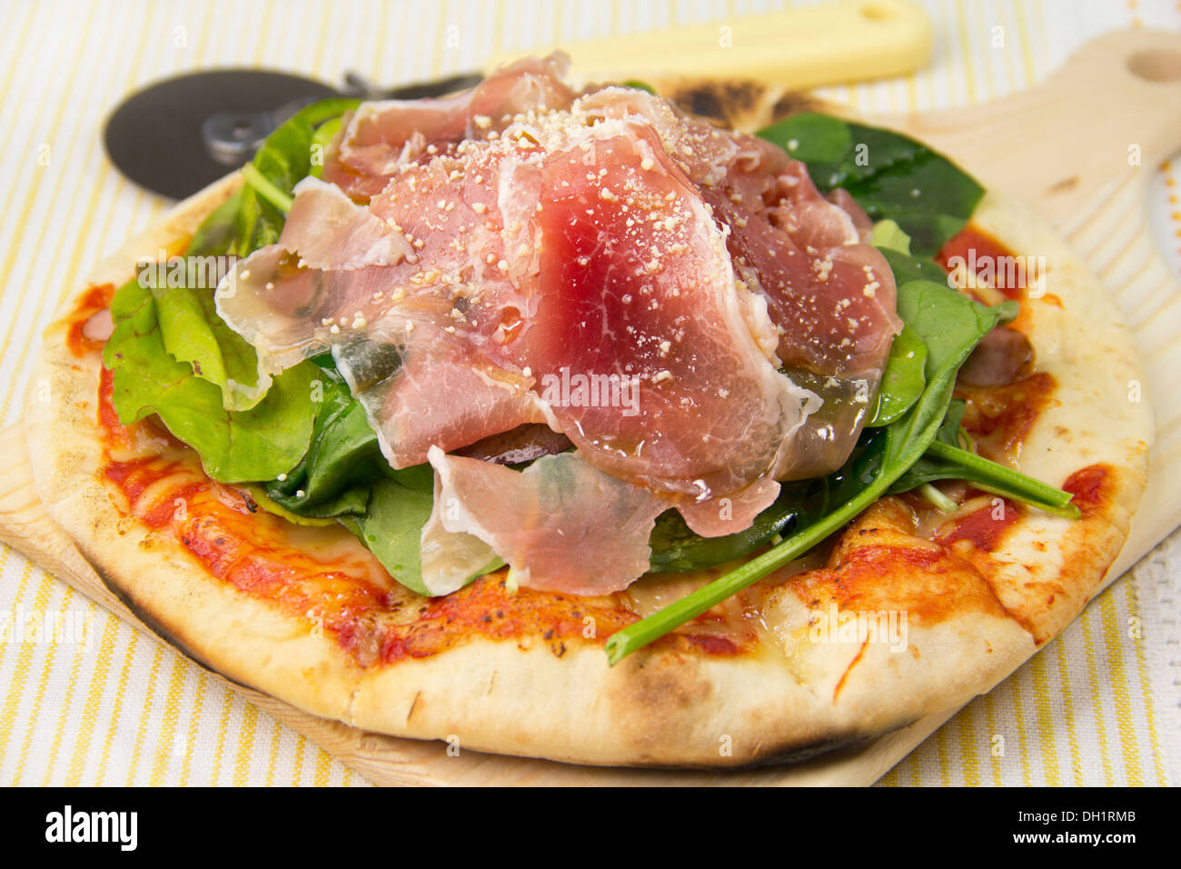 Pizza with raw ham and rocket Stock Photo - Alamy