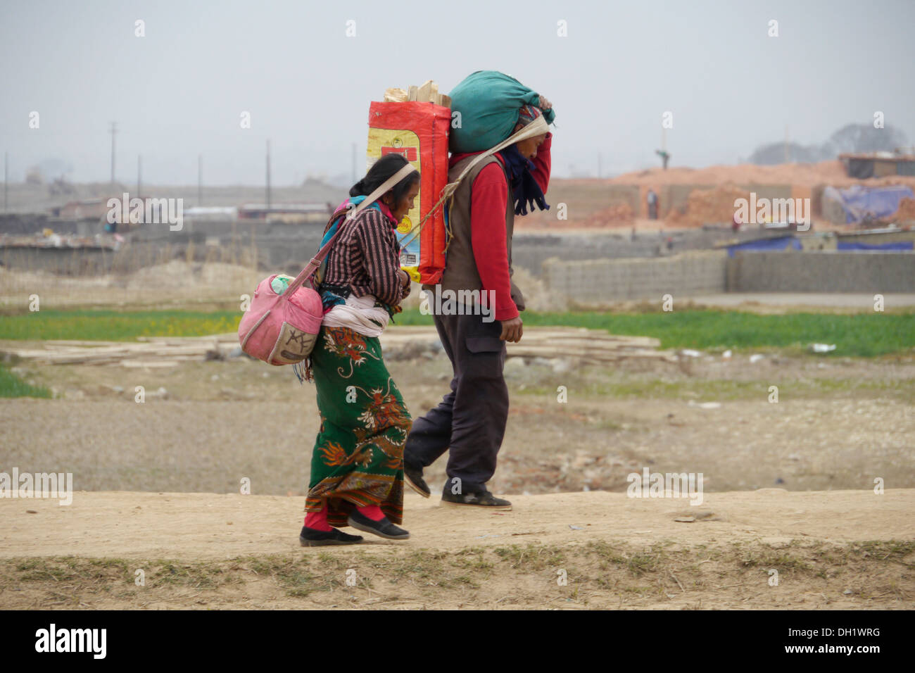 Nepal Man and woman carrying load Stock Photo - Alamy