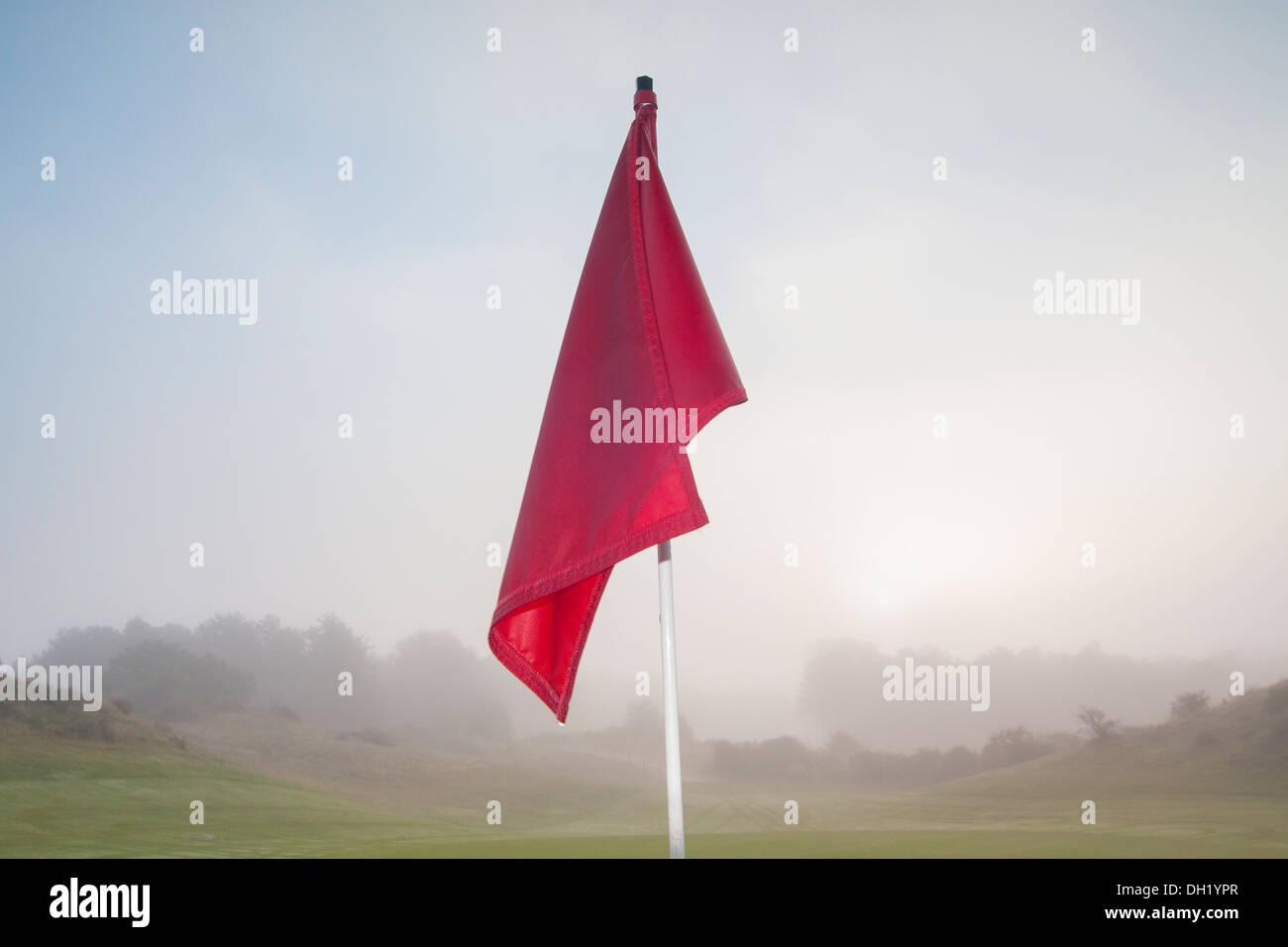 Limp, red, golf flag in close-up Stock Photo - Alamy