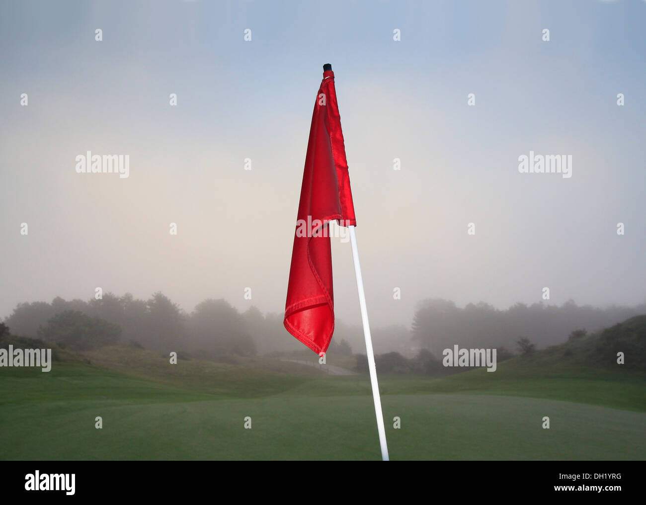 Limp, red, golf flag in close-up Stock Photo - Alamy