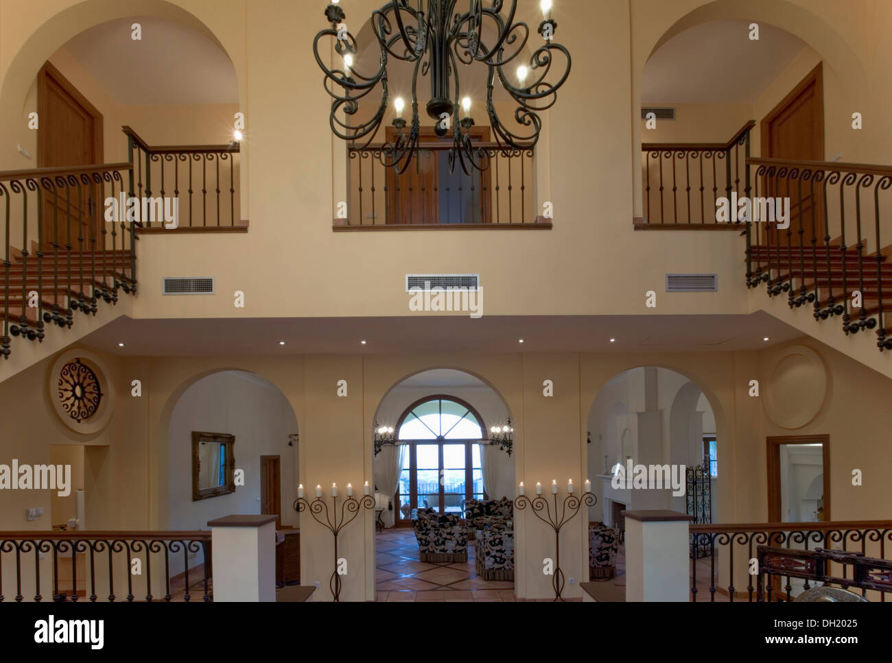 Large open plan hall with double staircases to gallery landing in ...