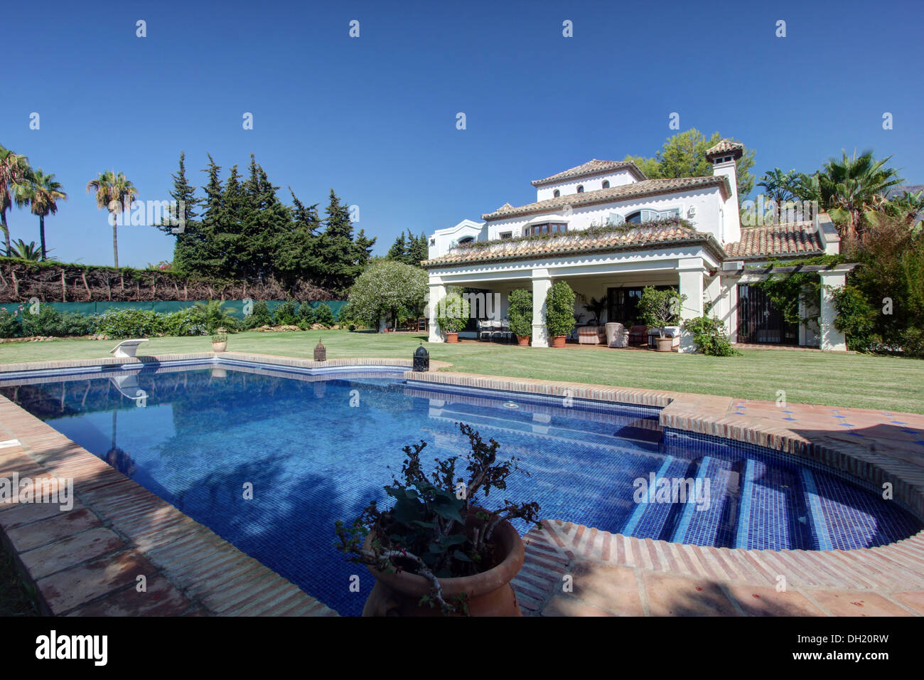 Blue swimming pool in well maintained grounds of large modern Spanish ...