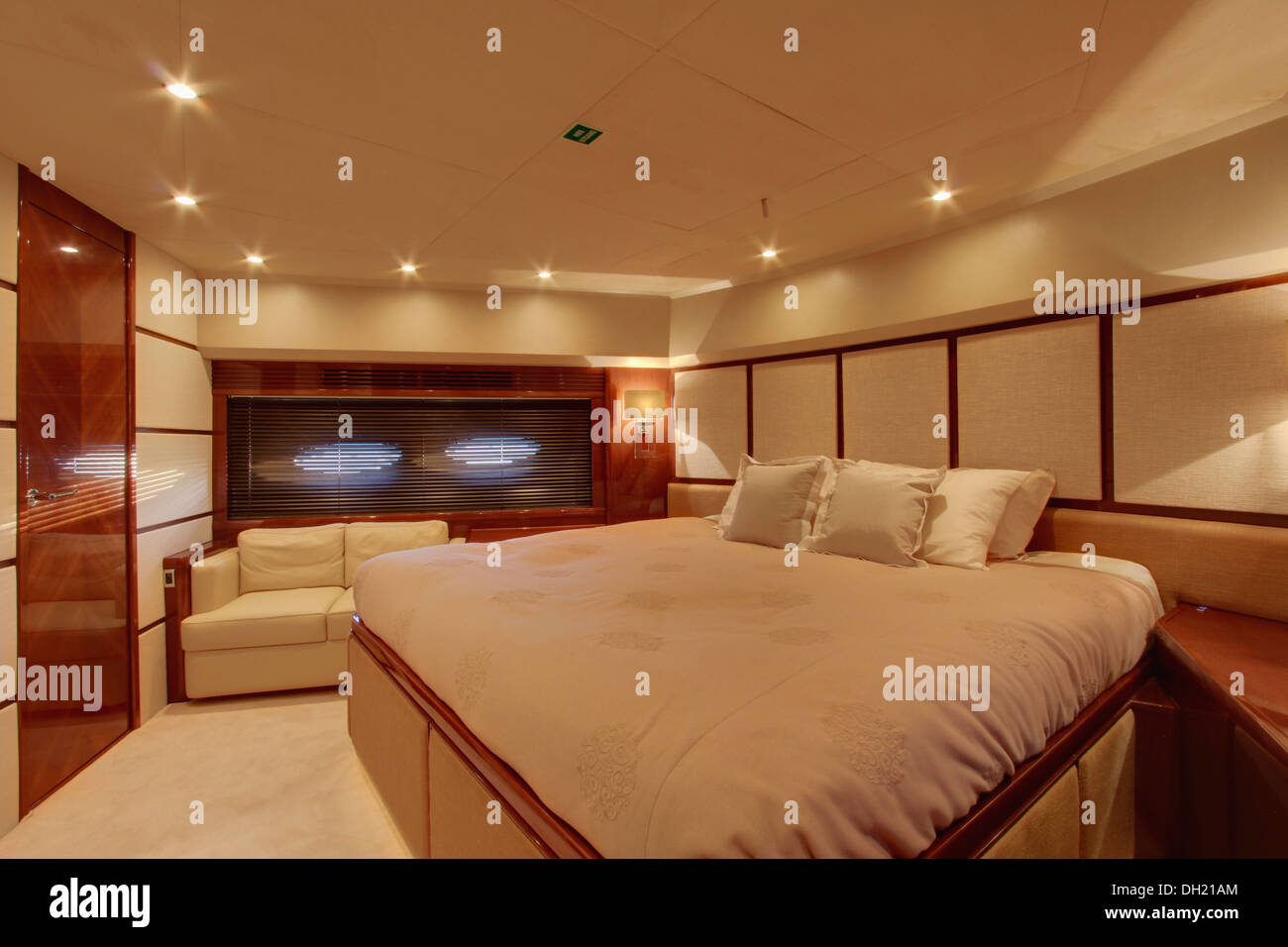 Down lighting in stateroom in large modern boat with fitted bed-cover ...