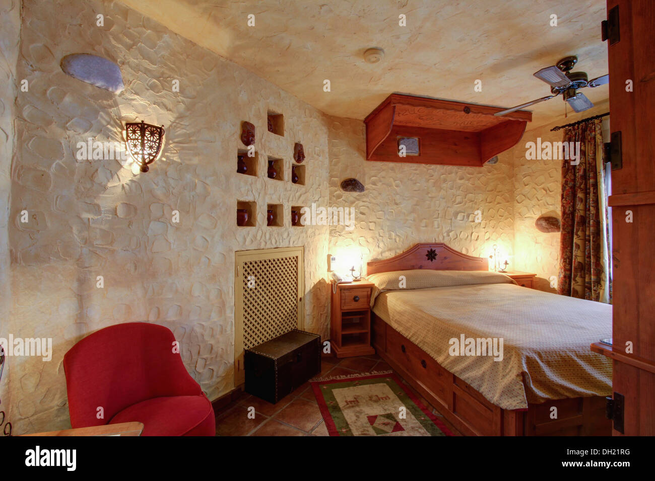 Wooden Canopy Above Bed In Spanish Bedroom With Rough Textured Walls And Lighted Metal Lantern wooden-canopy-above-bed-in-spanish-bedroom-with-rough-textured-walls-and-lighted-metal-lantern