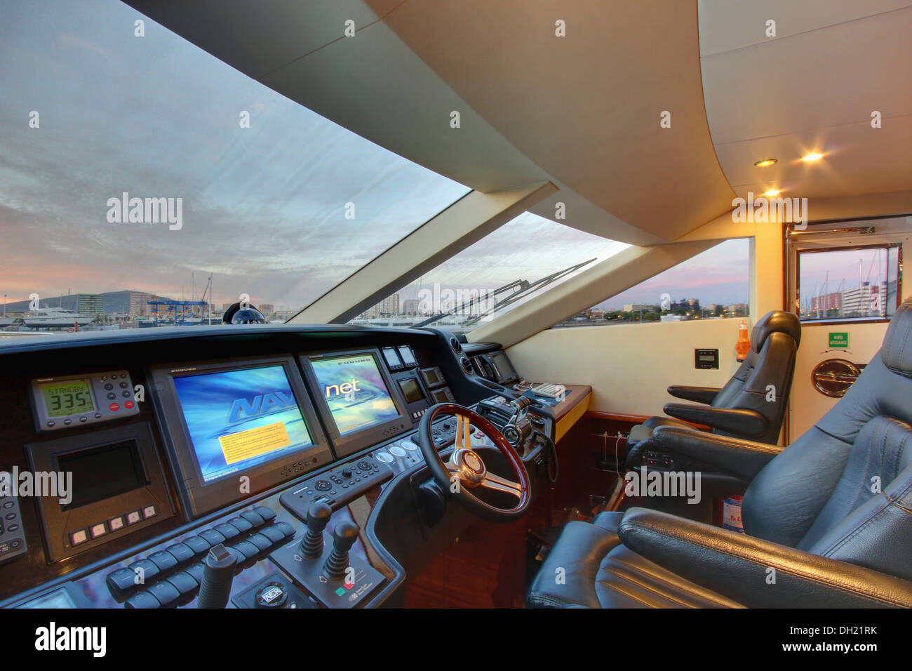 Interior of cockpit of large boat with screens and leather seats ...