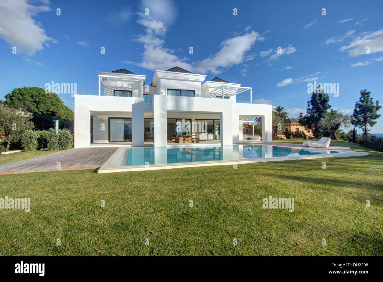 Swimming pool and lawn in front of large modern villa with spacious ...