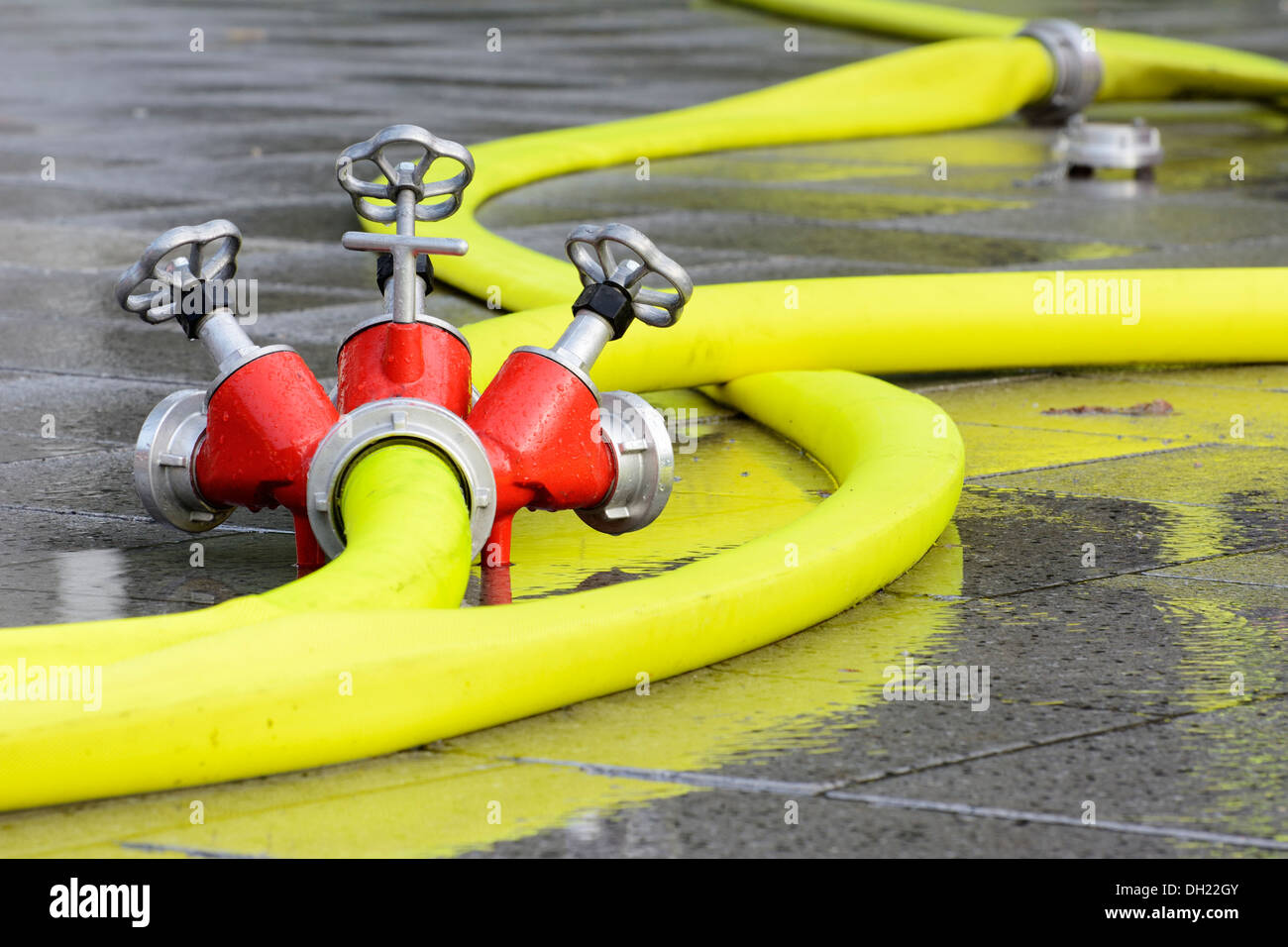 Firehose connected to a distribution device with faucet Stock Photo - Alamy