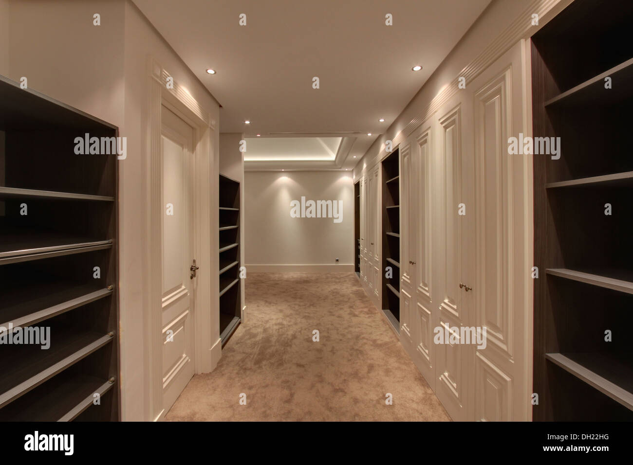 Beige carpet in empty dressing room in large, newly built villa in ...