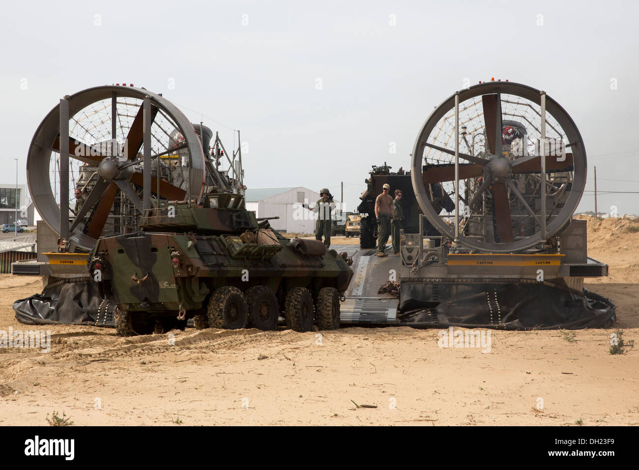 Sailors from Assault Craft Unit (ACU) 4 direct a light armored vehicle ...
