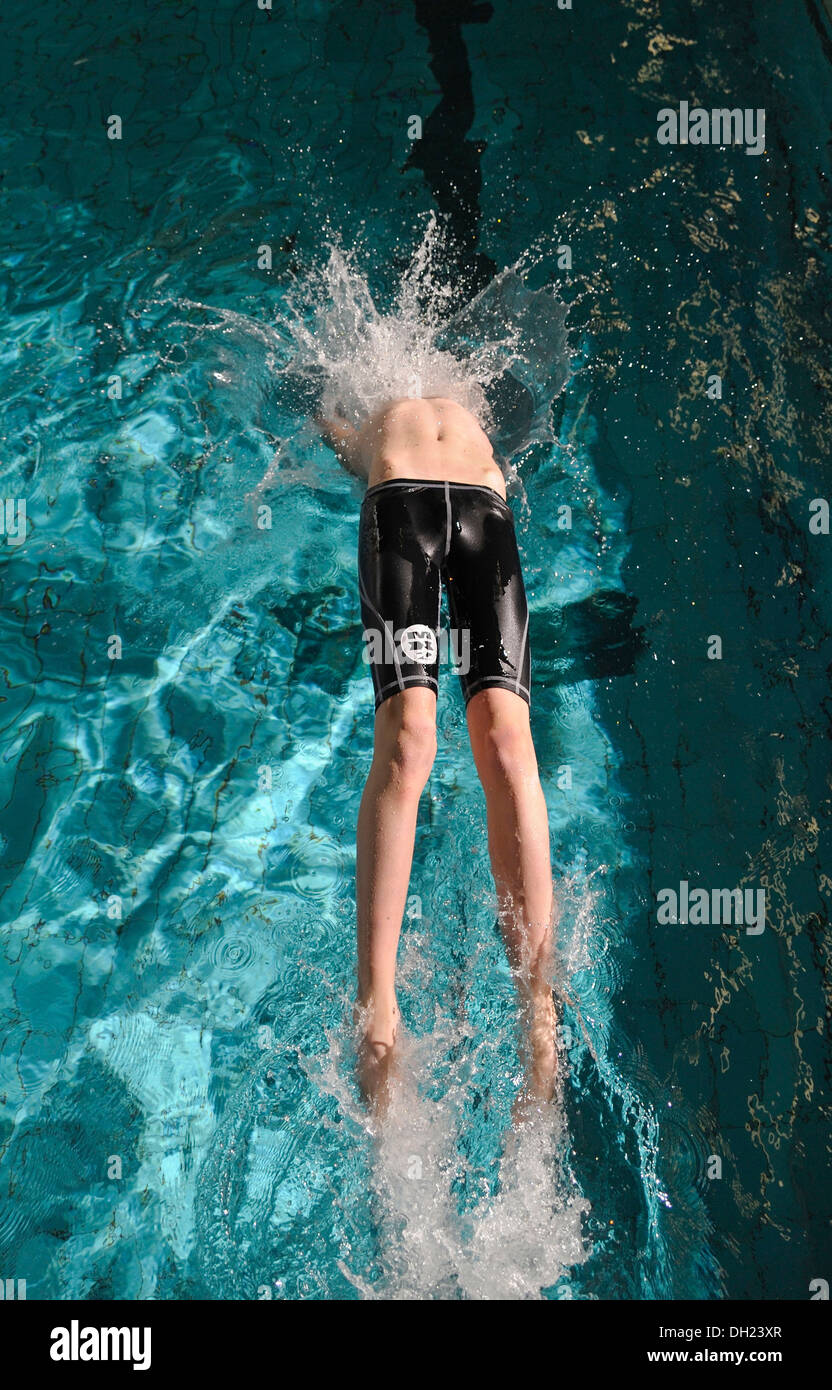 Boy, swimmer, 12 or 13 years, during backstroke start at the swimming ...