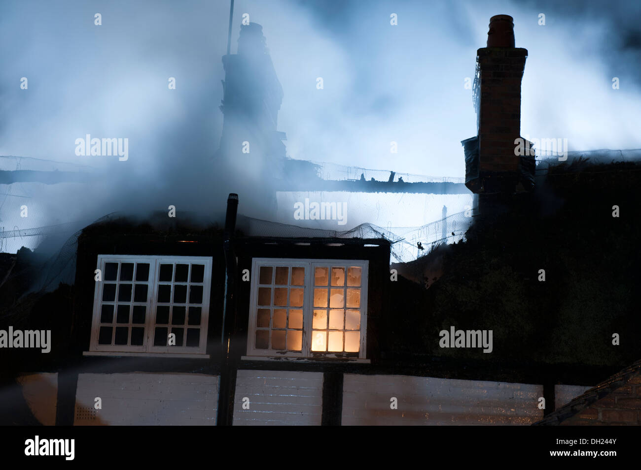 Thatched Cottage Roof on Fire at Night Stock Photo - Alamy