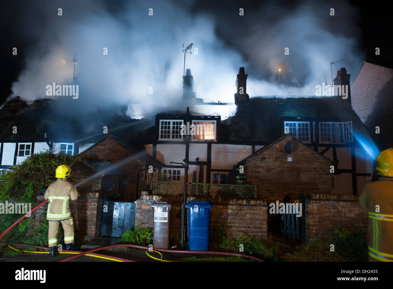 Thatched Cottage Roof on Fire at Night Stock Photo - Alamy