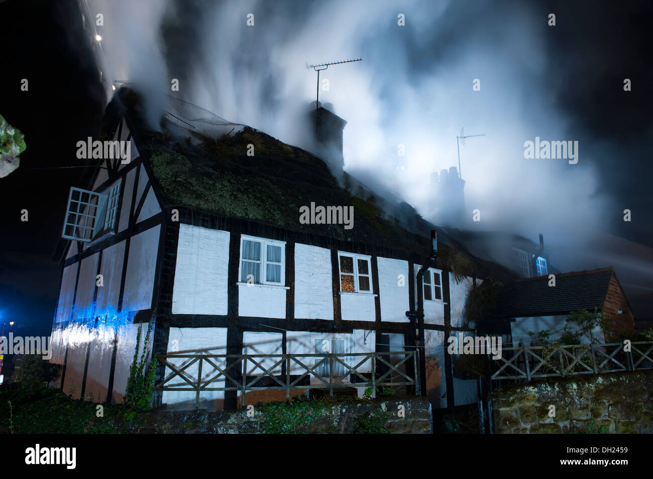Thatched Cottage Roof on Fire at Night Stock Photo - Alamy