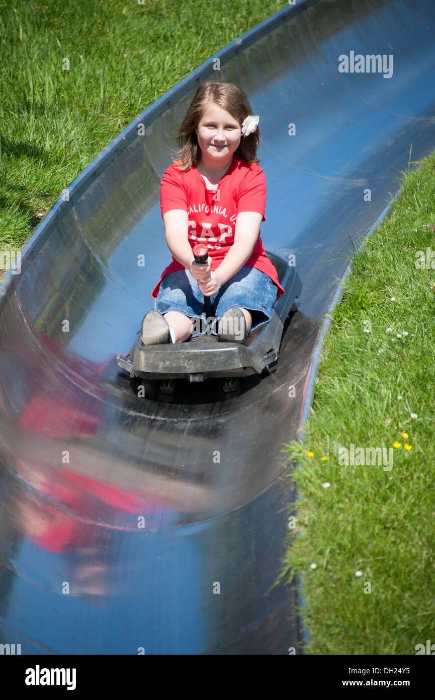 Young girl on toboggan slide mat fun ride. FULLY MODEL RELEASED Stock ...