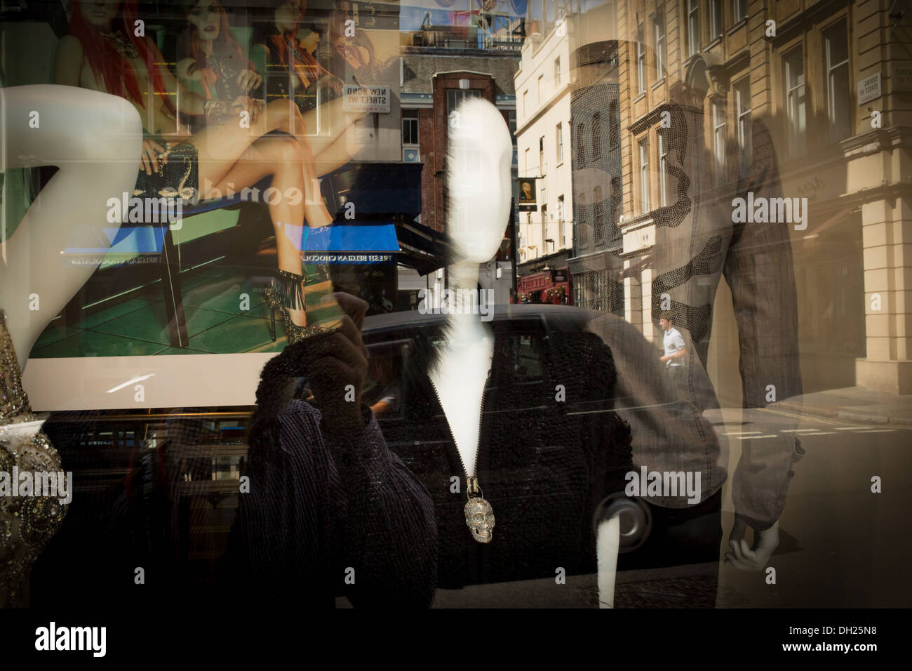multiple reflections in shop window including mannequin Stock Photo - Alamy
