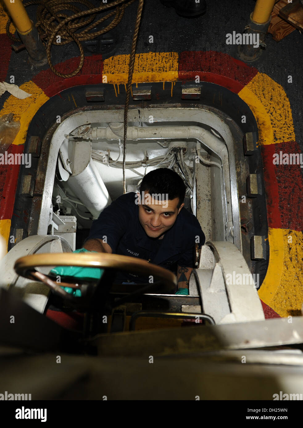 Machinist's Mate Fireman Xavier Rivera, from Cedarburg, Wis., climbs a ...