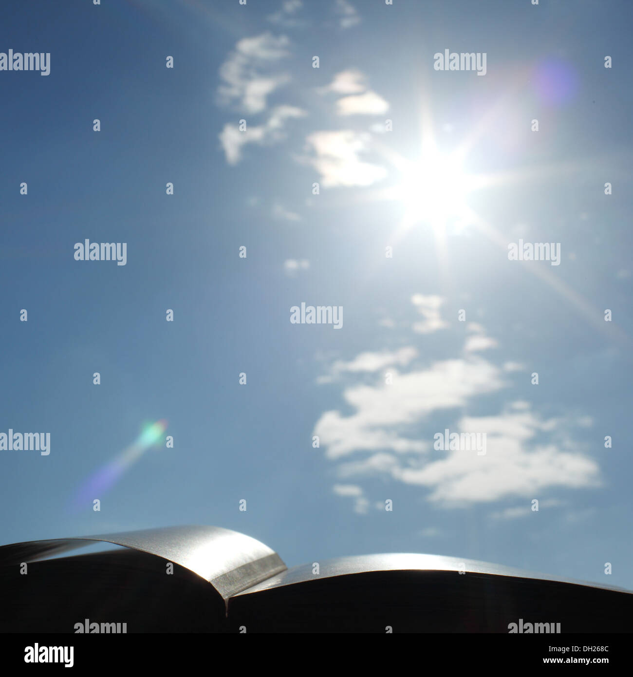 book of wisdom on sun sky background Stock Photo - Alamy
