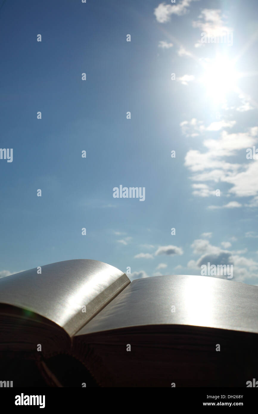 book of wisdom on sun sky background Stock Photo - Alamy