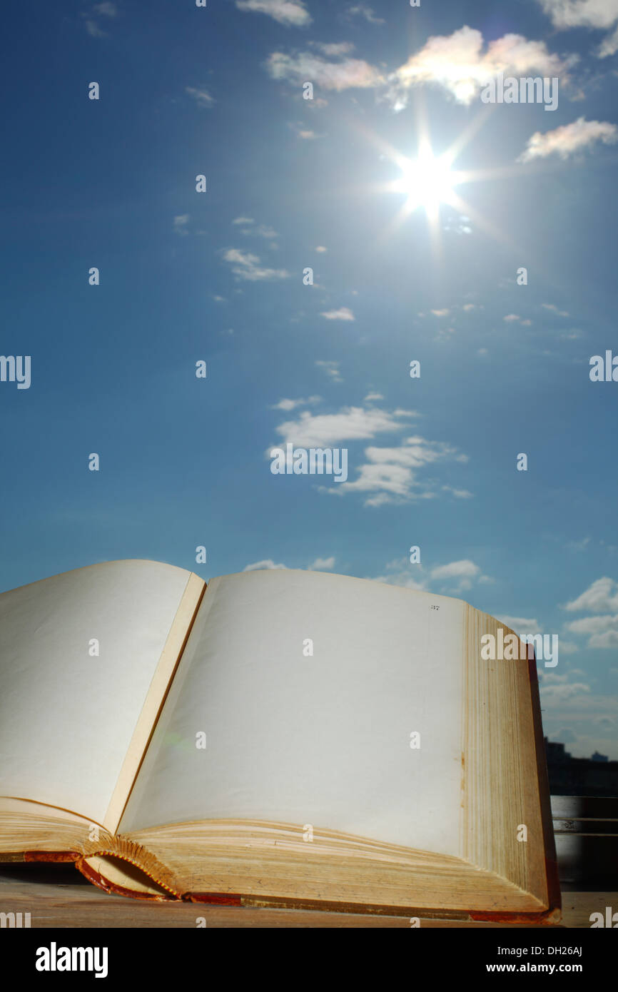 book of wisdom on sun sky background Stock Photo - Alamy