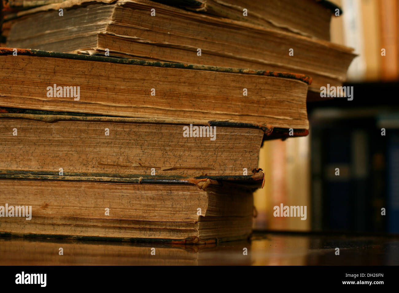 books on table in dark library room Stock Photo - Alamy