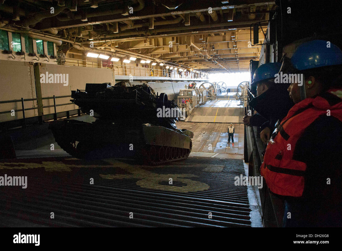A M1A1 main battle tank drives from a landing craft air cushion (LCAC ...