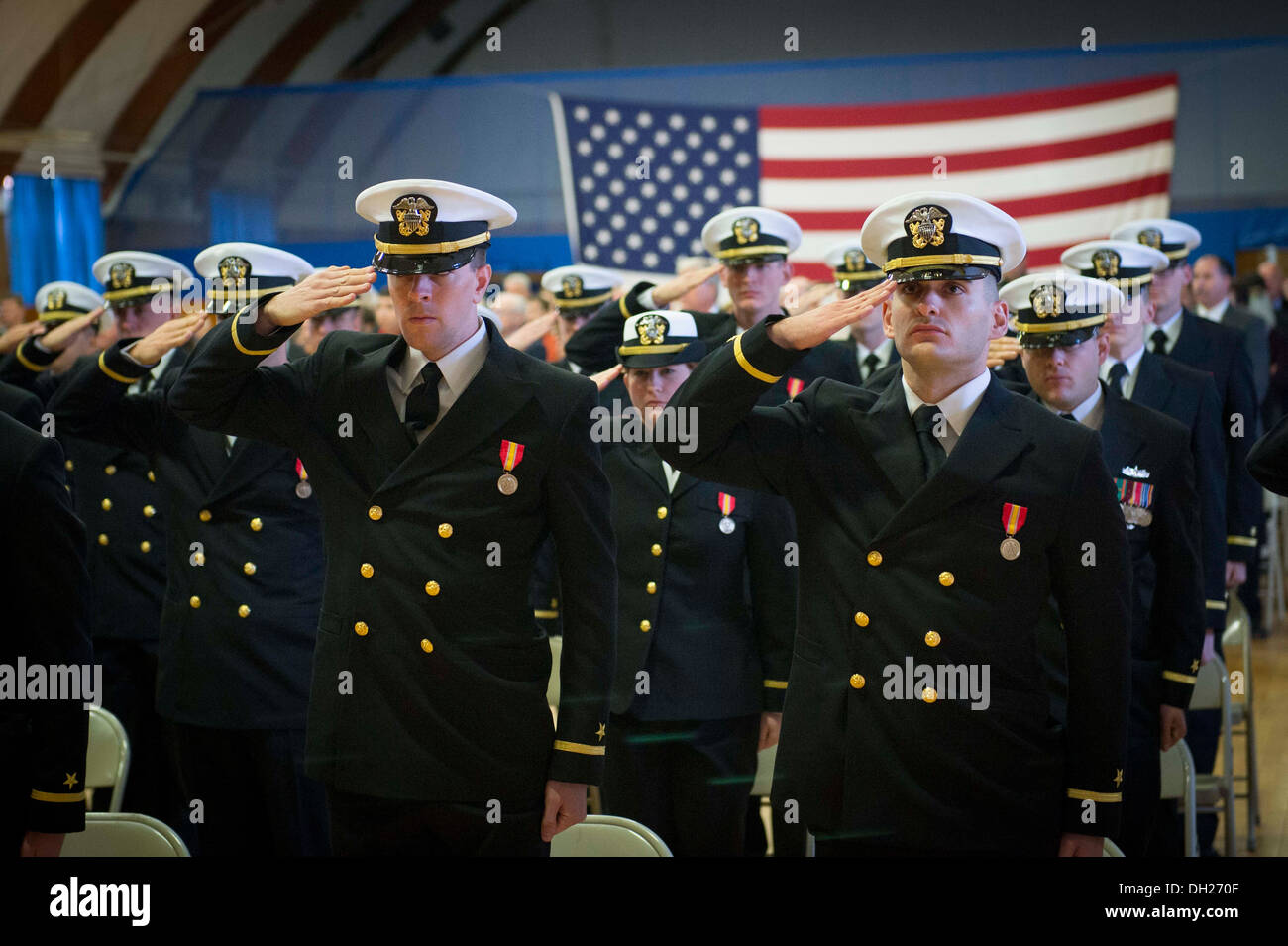 Officer candidates salute during the playing of the national anthem at ...