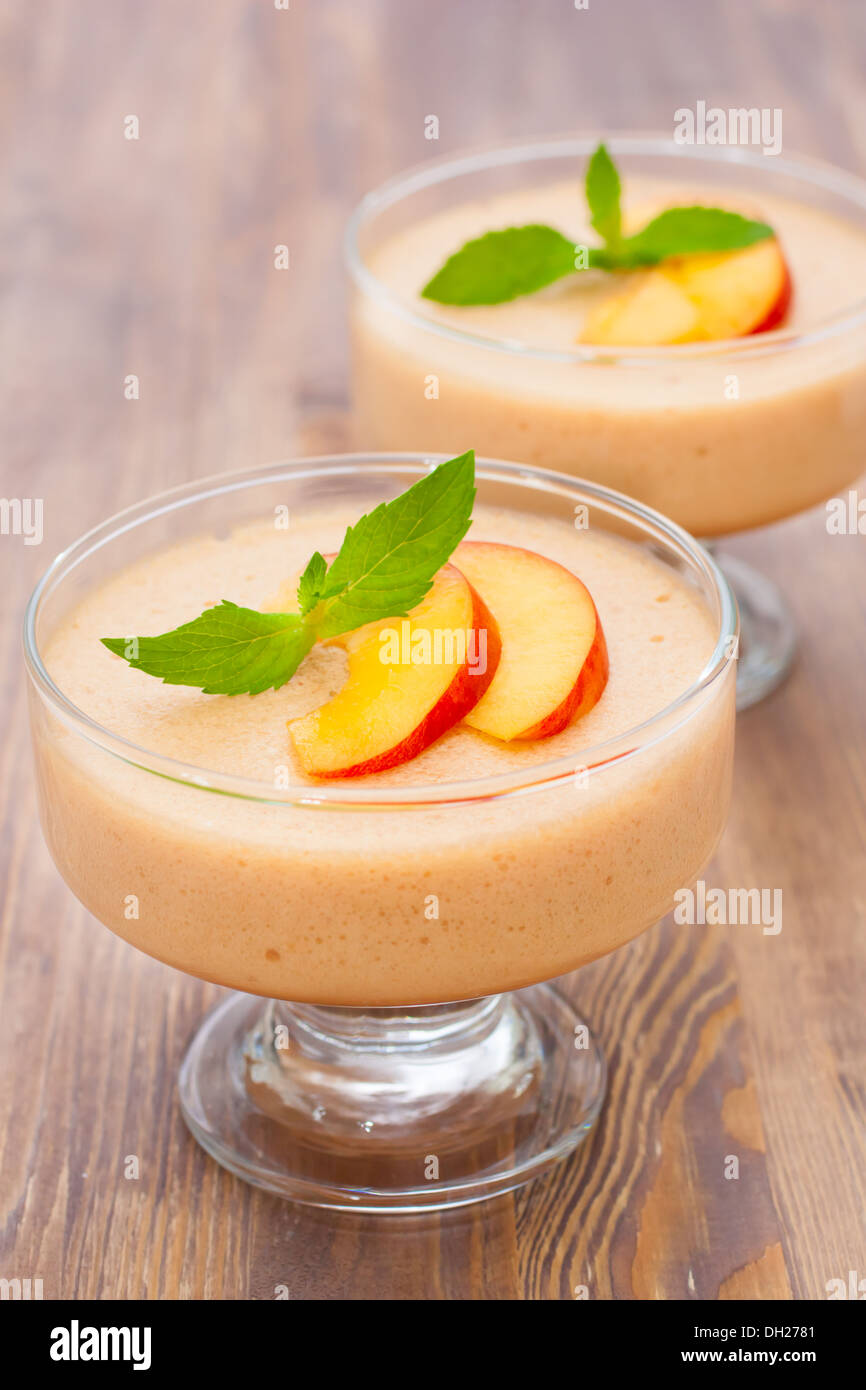 Delicious peach mousse in glass, wooden backrgound Stock Photo - Alamy