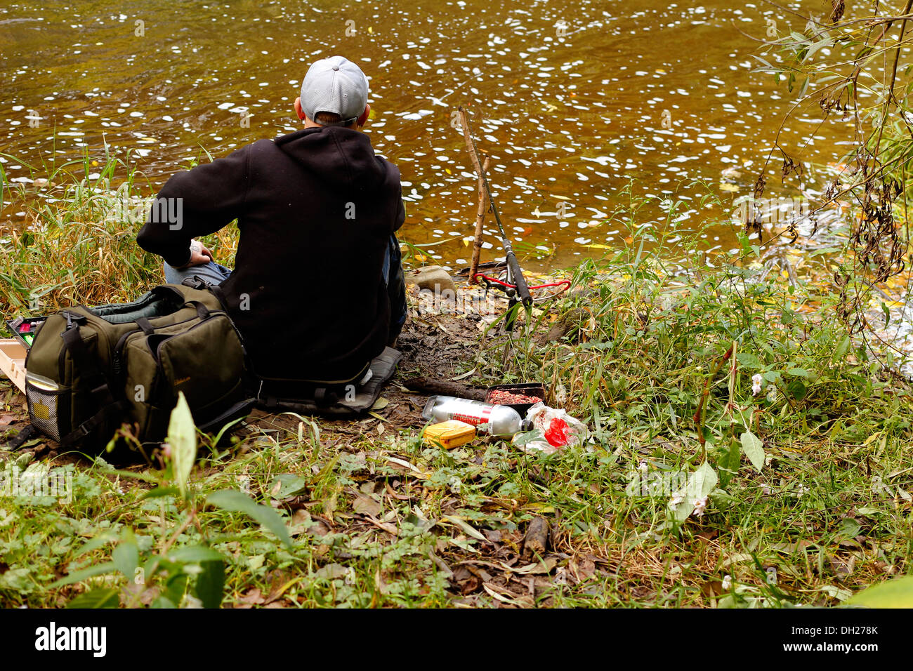 fisherman on the bank of a small river in Newtown, Powys in Mid Wales ...