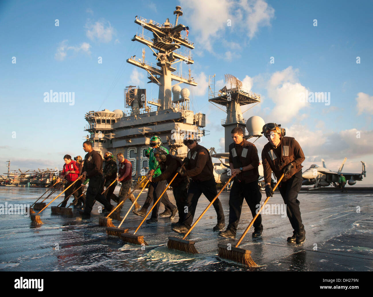 Sailors scrub the flight deck of the aircraft carrier USS Nimitz (CVN ...