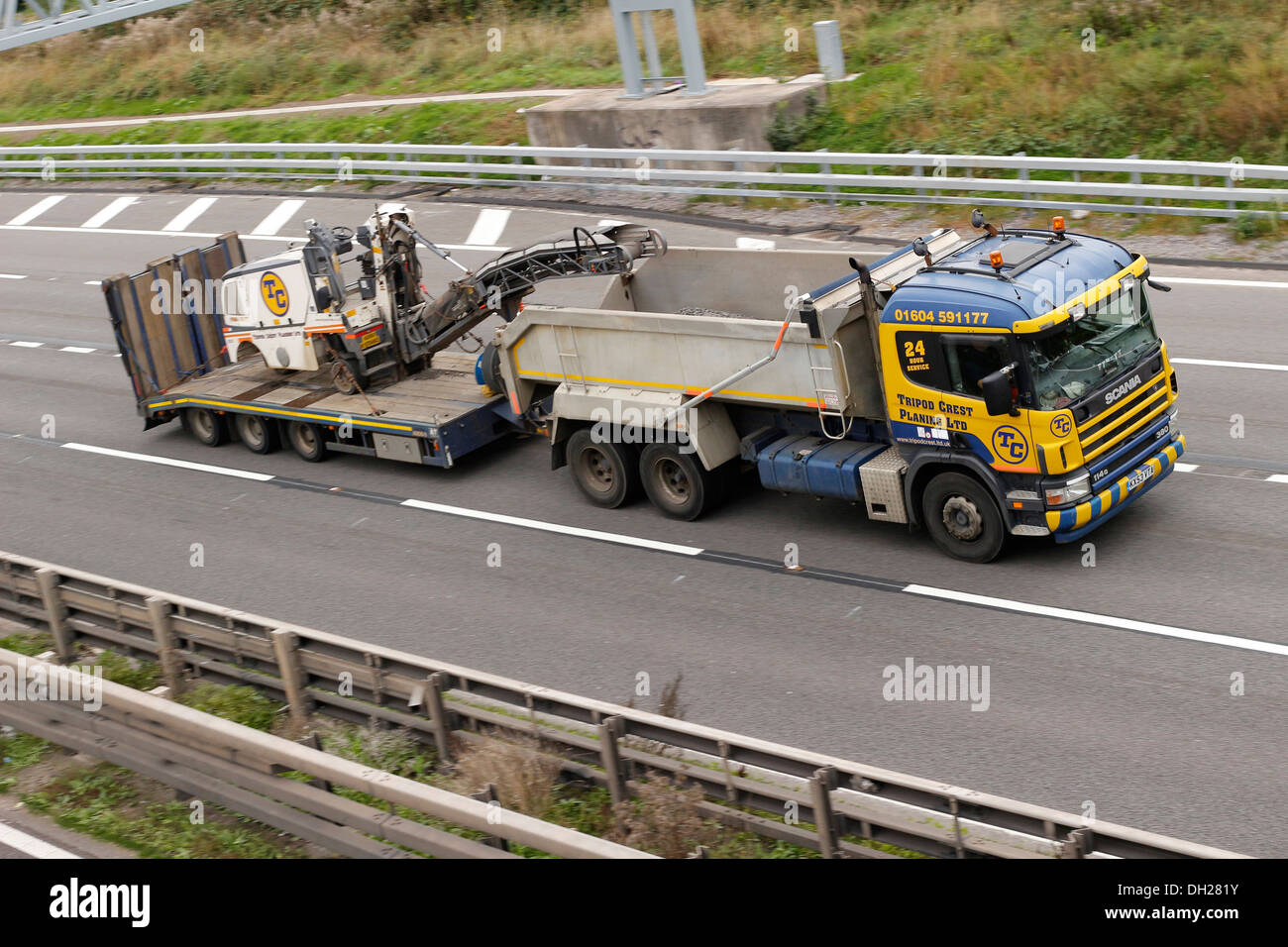Asphalt planer being hauled Heavy freight transport on the M4 motorway ...