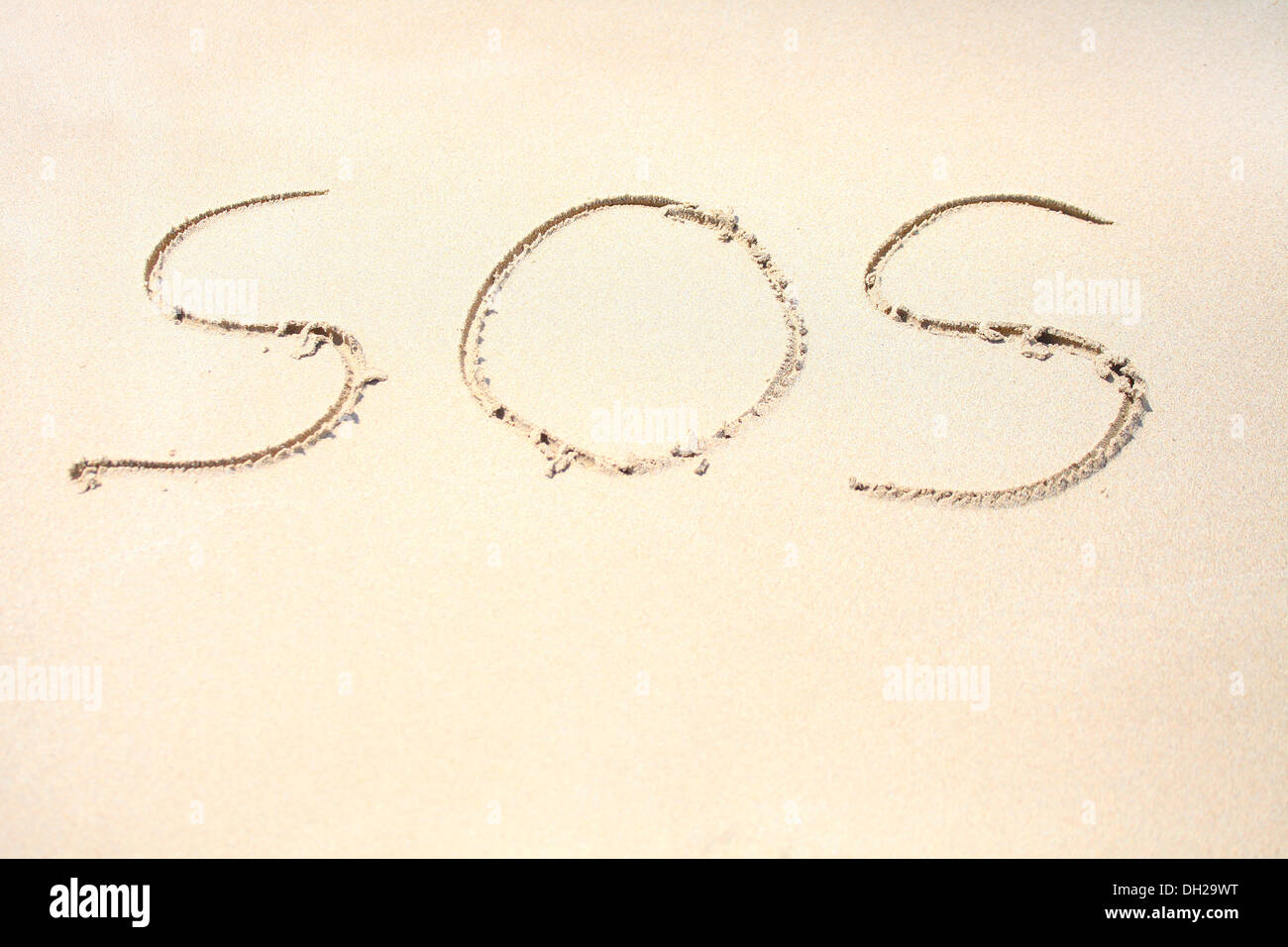 Drawing of SOS on the beach sand Stock Photo - Alamy