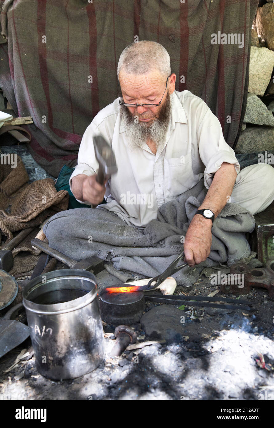 Indian blacksmith using exploded Pakistani artillery shell base as an ...