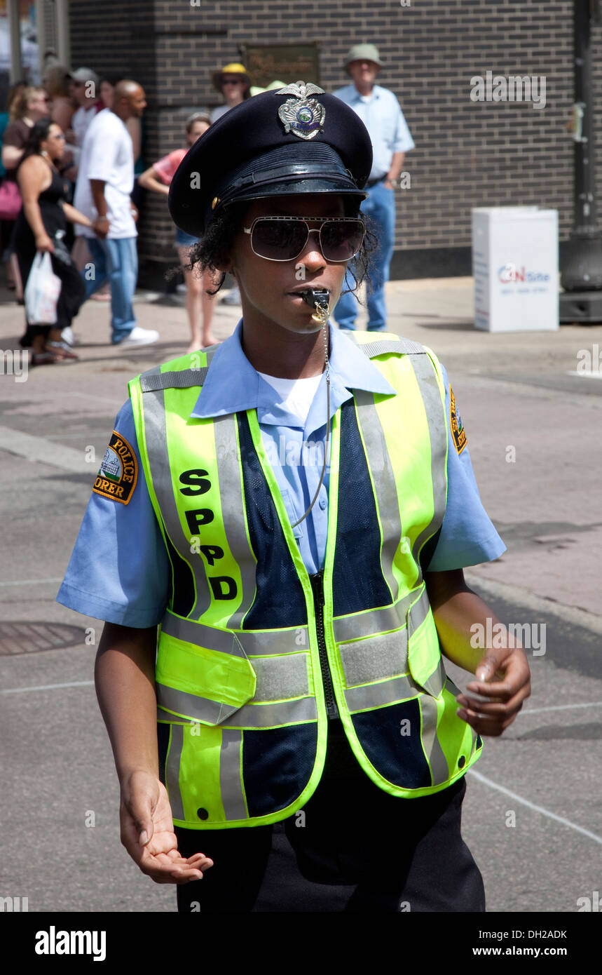 Black police woman calmly directing traffic. Grand Old Day Festival ...
