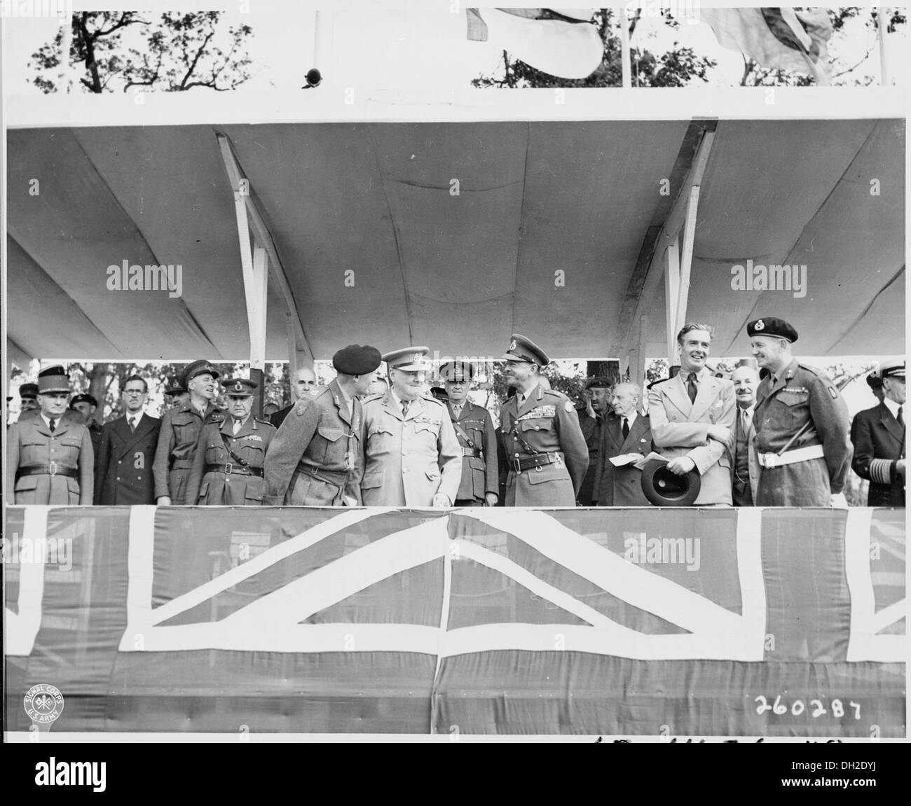 Notables sit in the reviewing stand during the British victory parade ...