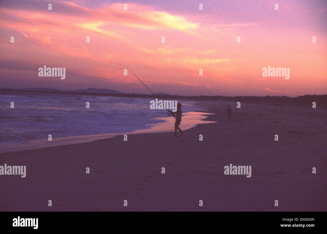 Beach fishing and sunset afterglow Stock Photo - Alamy