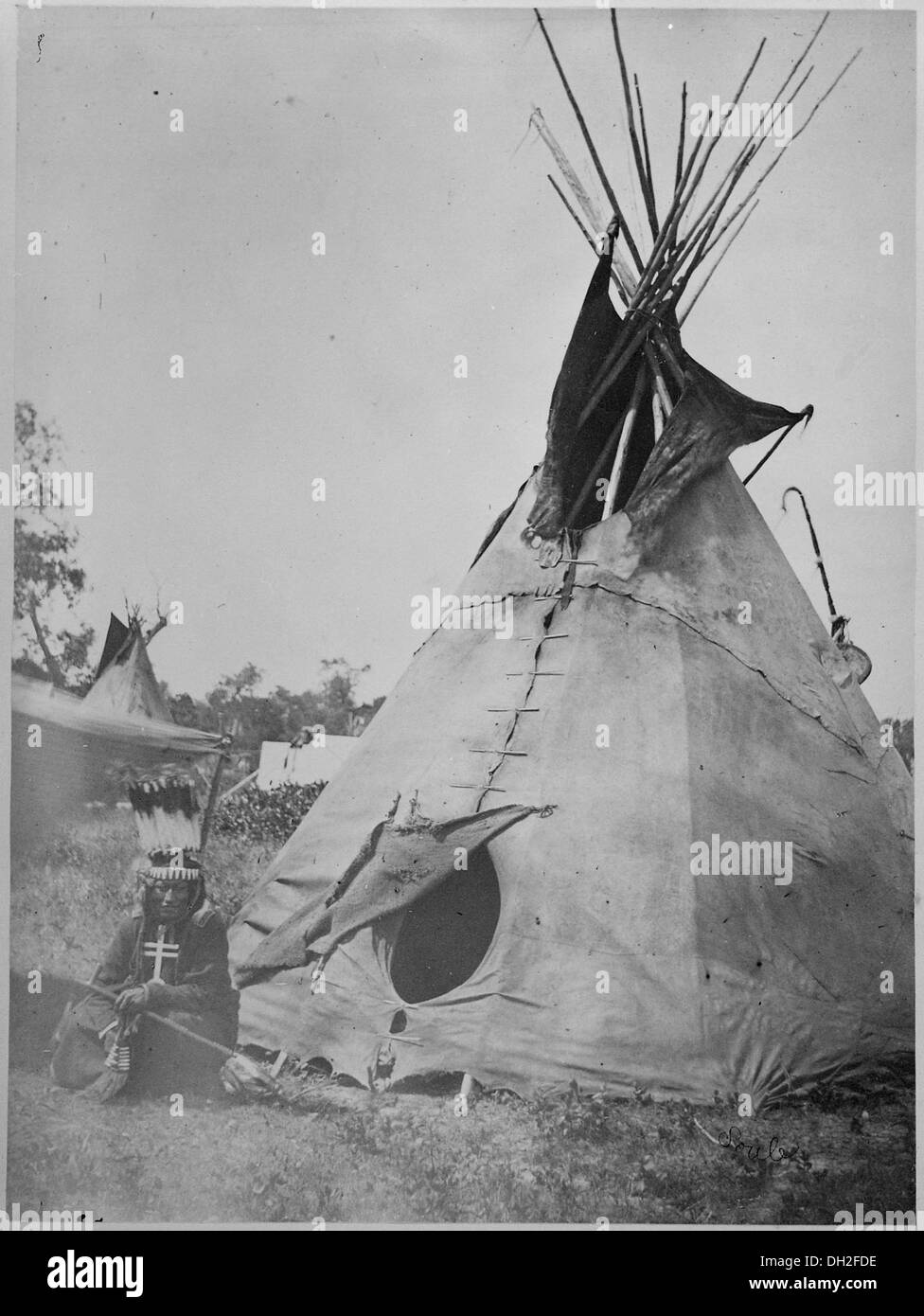 This historical photograph shows Gabe Gobin, an Indian logger, in front ...