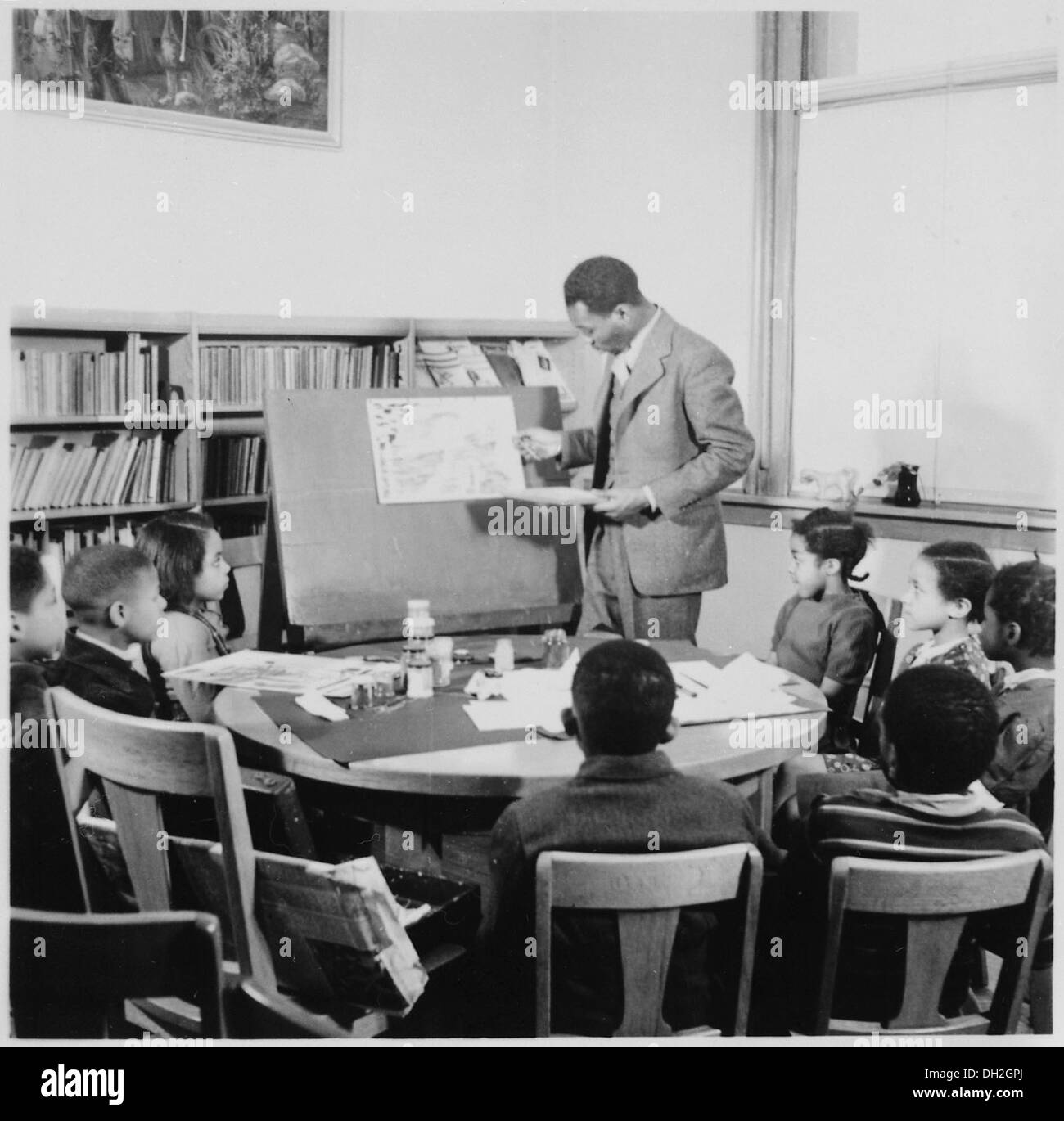 Jacob Lawrence, a renowned African American artist, is seen giving a ...